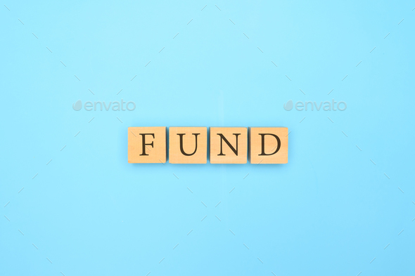 Fund text written on wooden block with abstract blue background Stock ...