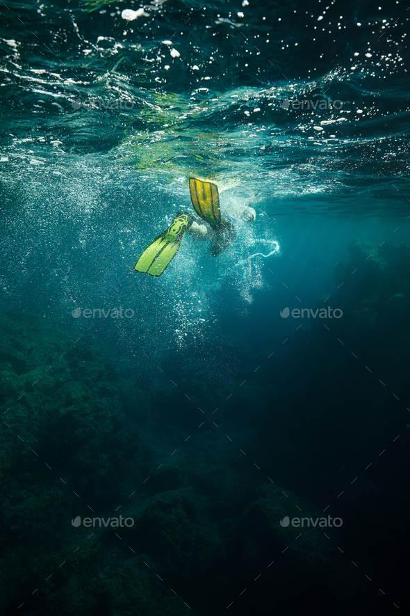 Diver swimming under water in flippers Stock Photo by ADDICTIVE_STOCK