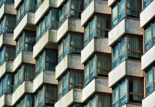 High building with lines of windows and balconies on a sunny day Stock ...
