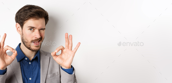 Close up of confident handsome man assuring all good, showing okay ...