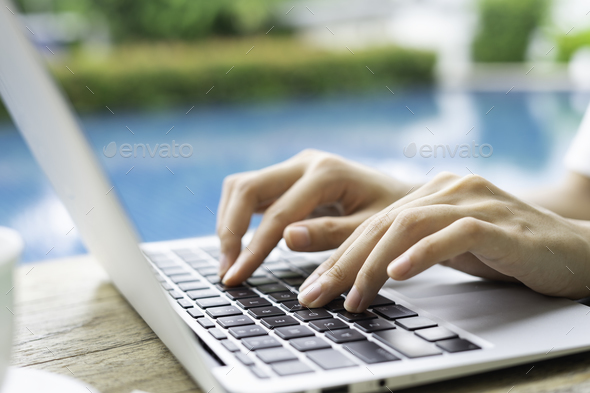 Hand close-up photo of an Asian female office worker Typing on the ...