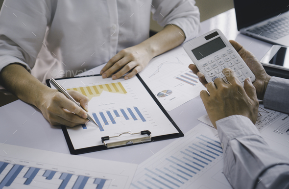 female finance staff is showing her leader a graph of the performance ...