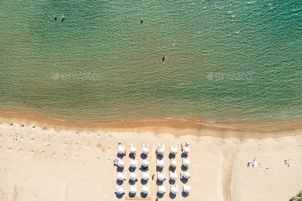 Greece Cyclades island, sandy beach, aerial drone view. People swim and ...