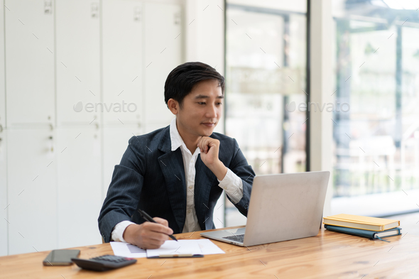 Smart businessman working on his project with laptop computer in the ...