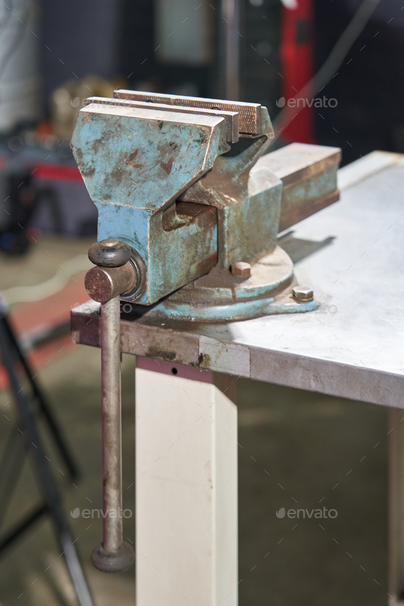 large metal bench vise fixed on the edge of the bench table Stock Photo ...