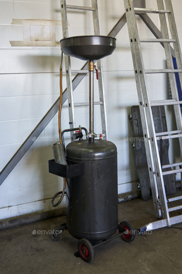 oil collection and replacement wheeled unit with drain funnel. Barrel ...