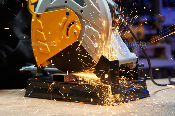 working electric cutting disc machine with sparks flying in different ...