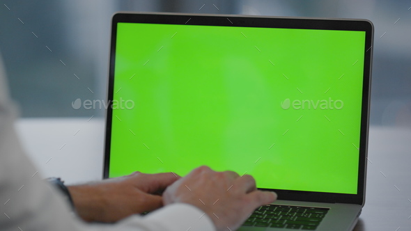 Hands writing green screen laptop in office closeup. Businessman typing ...