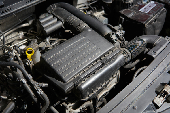 top view of the engine compartment, engine, car air filter, pipes, air ...