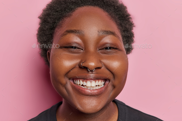 Headshot of radiant curly African girl beams with contagious smile ...