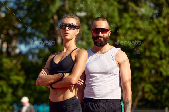 Handsome young athletes looking at the camera and smiling while ...