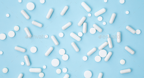 Various white medication tablets and capsulesd. Concept of healthcare ...