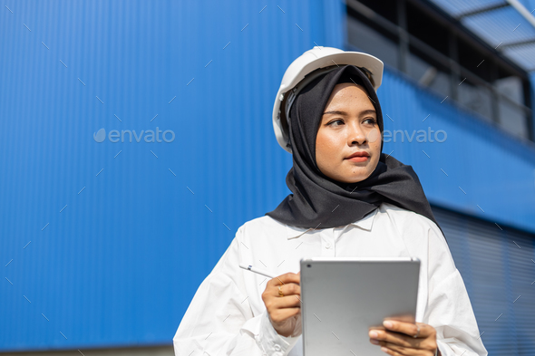 asian muslim woman industrial engineer in uniform wearing safety hard ...