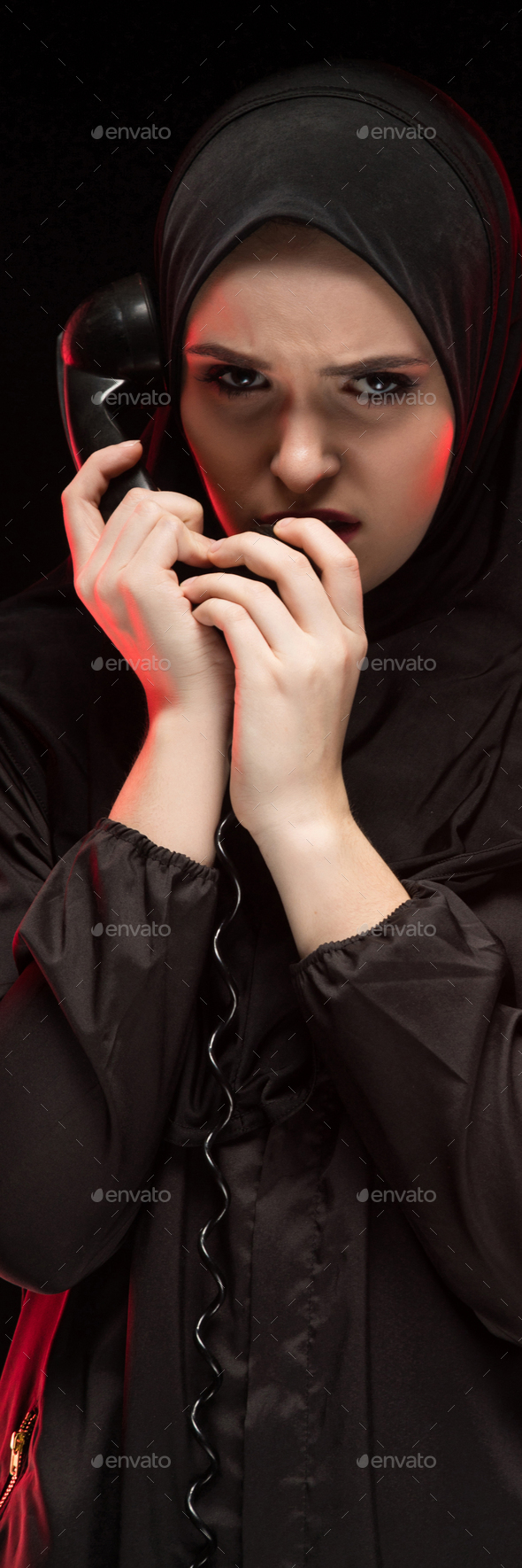 Portrait of beautiful serious scared young muslim woman wearing black ...