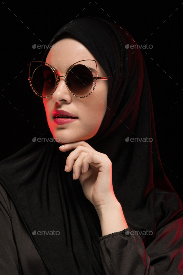 Portrait of beautiful stylish young muslim woman wearing black hijab ...