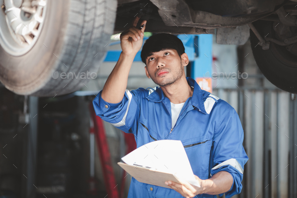 Professional car mechanic checking car undercarriage, all types of car ...