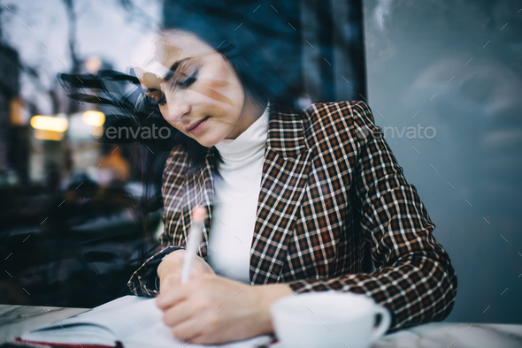 Serious woman taking note in notepad Stock Photo by GaudiLab | PhotoDune