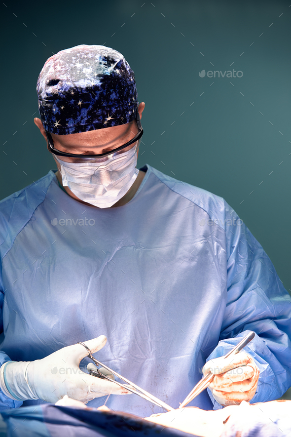Surgeon close-up in hard work in the operating room. Surgeon in ...