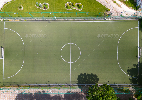 From an aerial perspective, an empty football field comes into view ...