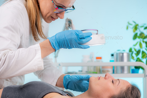 Unveiling Dermatological Changes on Patient’s Skin Stock Photo by microgen