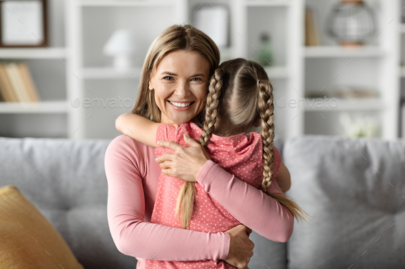 Mother Child Bonding. Happy Mom Embracing Her Little Daughter At Home Stock Photo by Prostock-studio