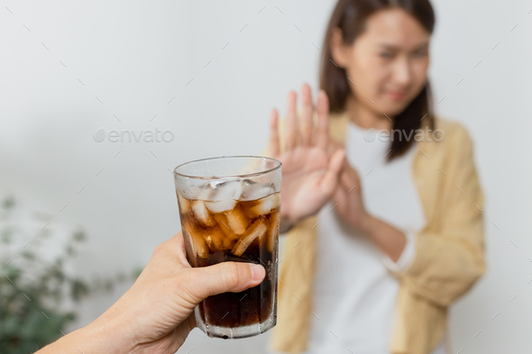 hand holding glass of black water. female reject drink sugar. Stock ...