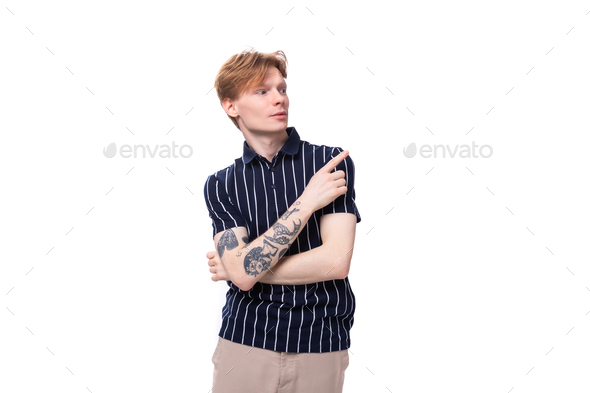 Handsome 25 Year Old Blond Male With Tattoos In A Striped Polo Points