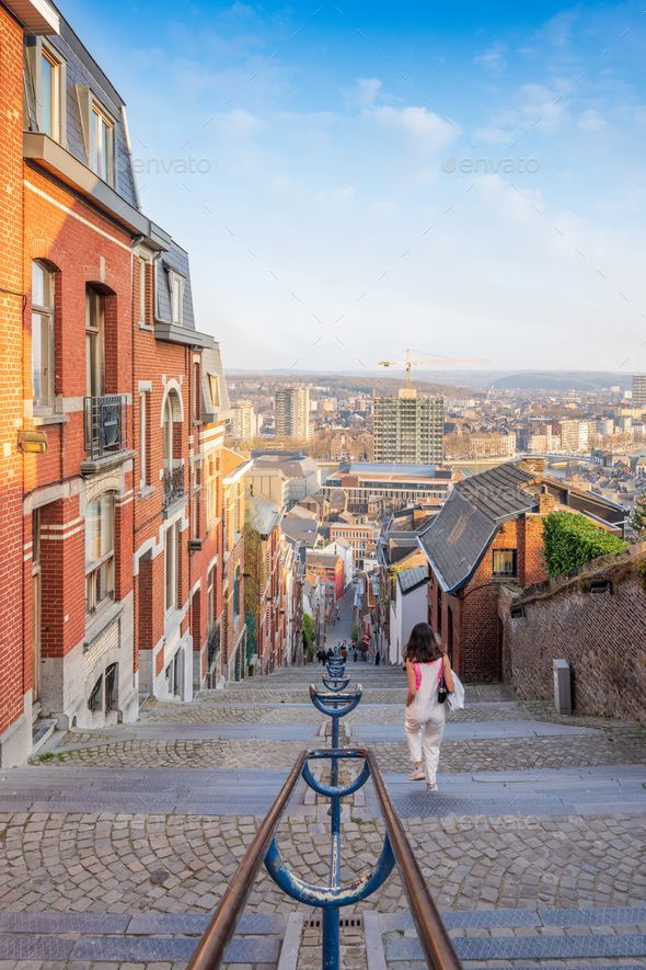 Scenic view of a female walking down the Montagne de Bueren stairway in ...