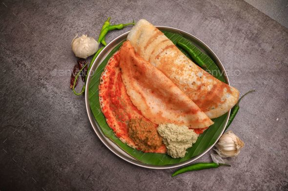South indian famous break fast dosa with chutneys served in a banana ...