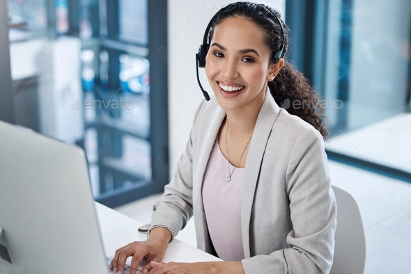 Young happy mixed race female call center agent using a desktop ...