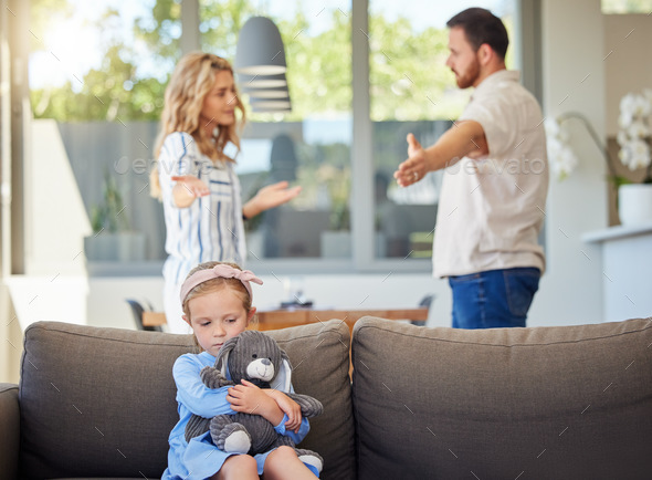 Kid feeling upset while parents argue in room. Couple arguing around ...
