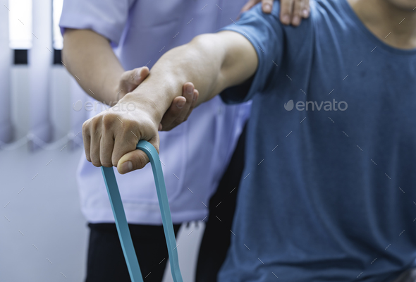 Physical therapist gives resistance band exercises. About the arms and ...