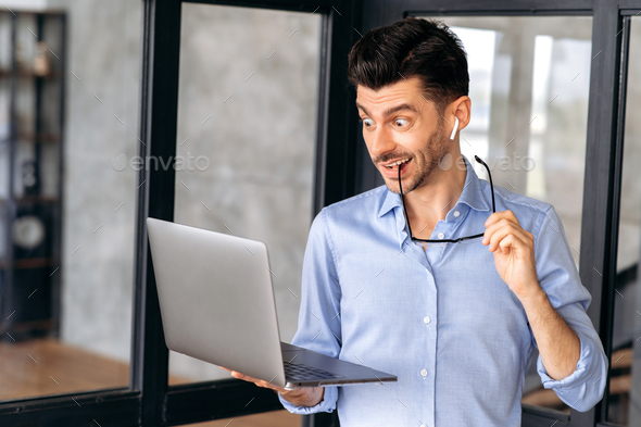 Shocked businessman received unexpected message or news, looking at ...