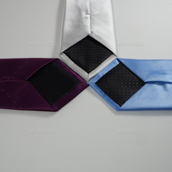 Three multi colored ties on a white background Stock Photo by wirestock
