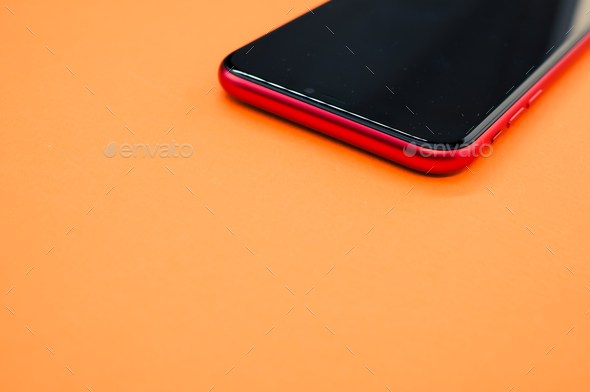 Closeup of a red smartphone isolated on an orange background Stock ...