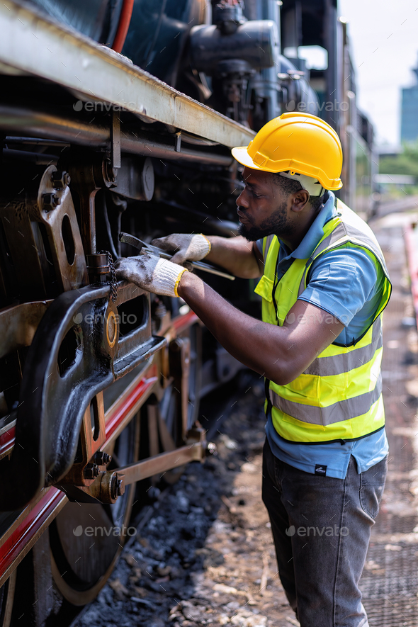 Engineer railway wearing safety gear checking train transmittal system ...