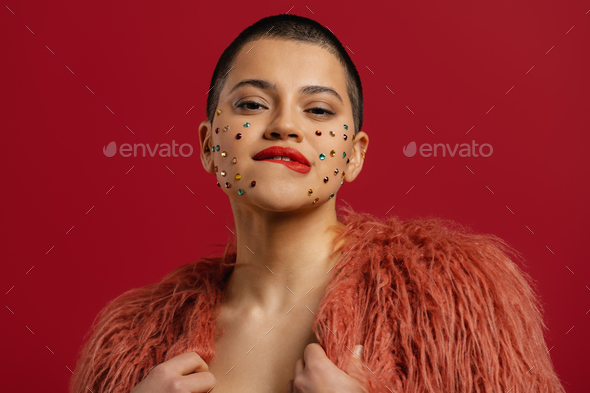 Fashionable short hair woman with shiny crystals over her face standing ...