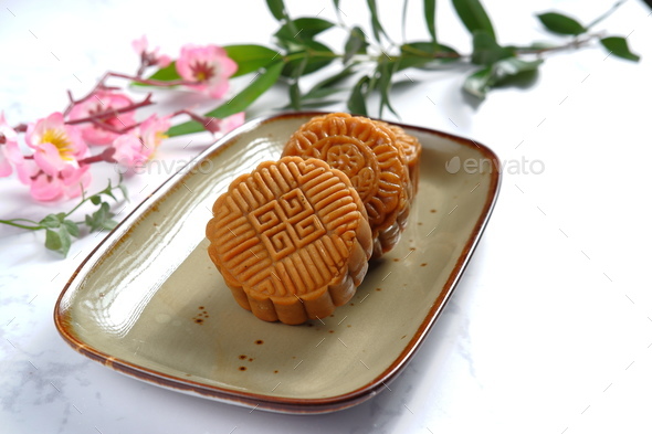 Mooncake, Moon cake (yue bing }-Chinese traditional pastry with tea cups on dark background, Mid ...