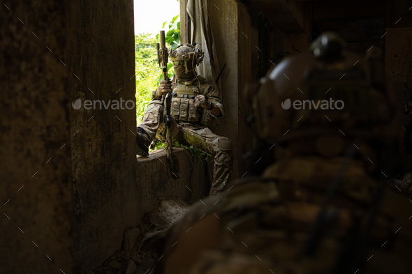 Special forces soldier in camouflage, Take refuge in an abandoned ...