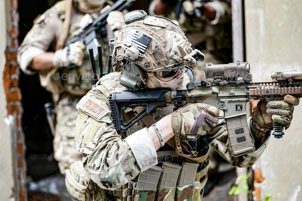 Soldier in full US MARSOC armed with assault rifle run through the ...
