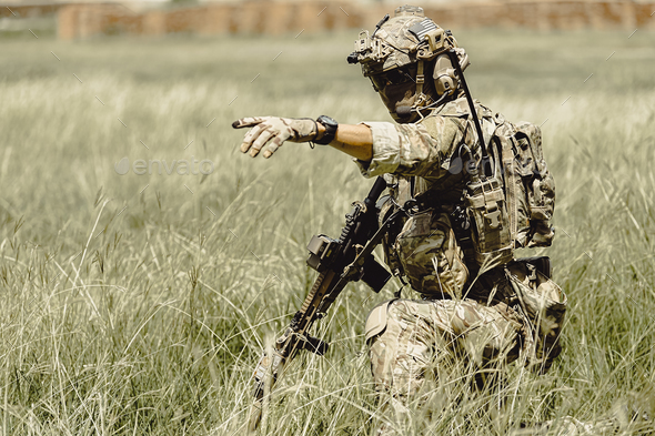Soldier in full US MARSOC armed with assault rifle run through the ...