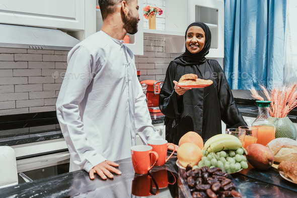 Happy middle eastern couple wearing traditiona larab clothing at home ...