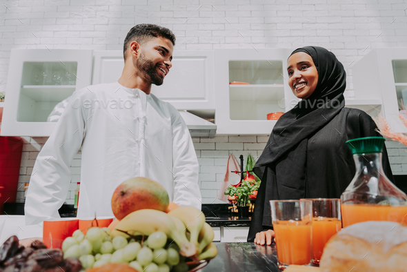 Happy middle eastern couple wearing traditiona larab clothing at home ...