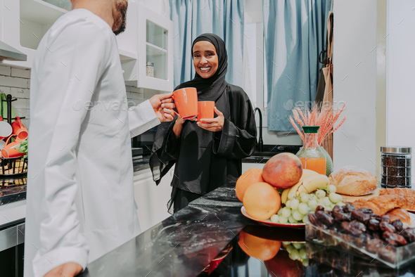 Happy middle eastern couple wearing traditiona larab clothing at home ...