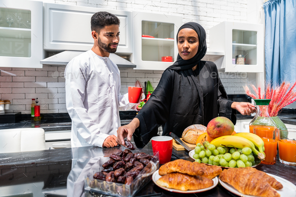 Happy middle eastern couple wearing traditiona larab clothing at home ...