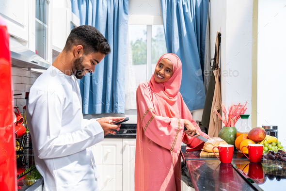 Happy middle eastern couple wearing traditiona larab clothing at home ...