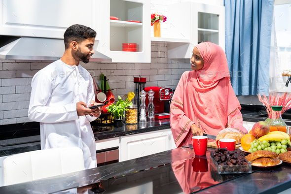 Happy middle eastern couple wearing traditiona larab clothing at home ...