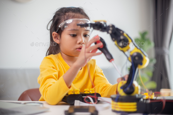 STEM education concept. Asian students learn at home by coding robot ...