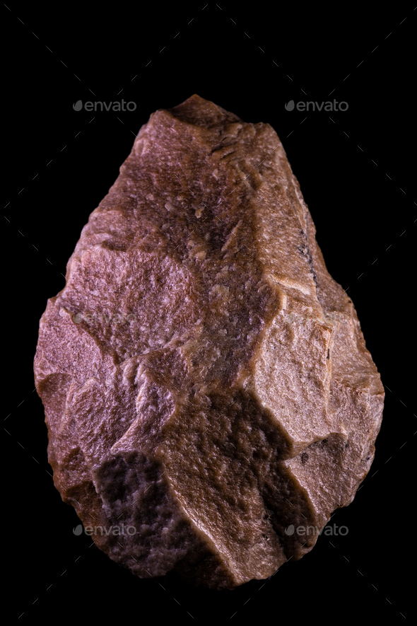 Ancient stone hand ax from the Paleolithic period Stock Photo by wirestock