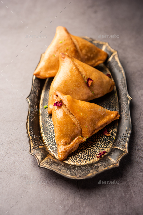 Indian sweet samosa is a Fried pastry soaked in sugar syrup filled with ...